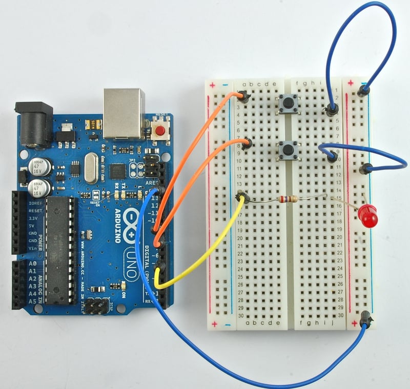 you just run wires between the button and the player - Arduino
